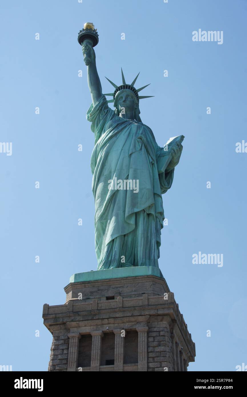 New York icon: Lady Liberty's torch pierces a clear blue sky, her ...
