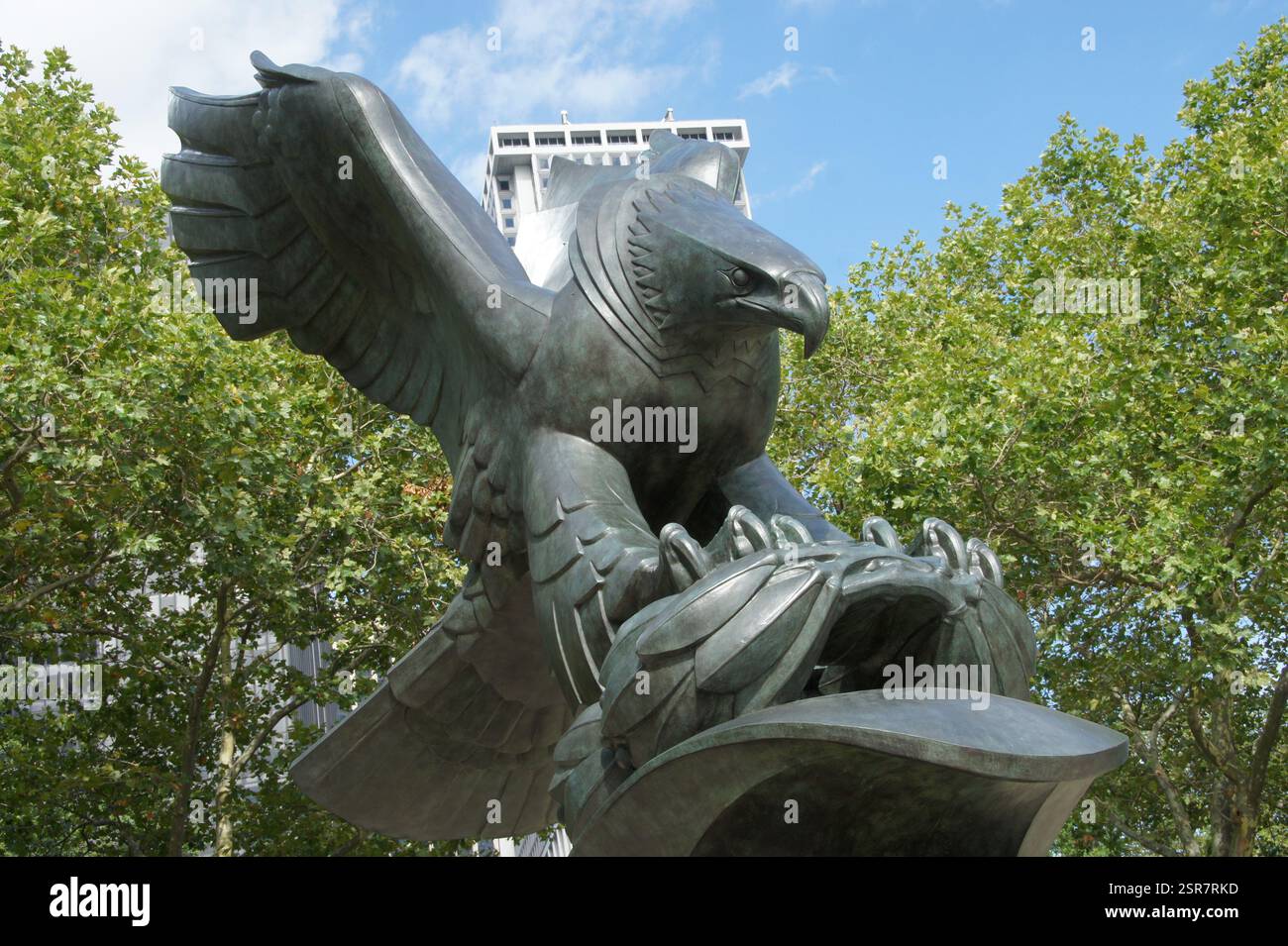 Bronze eagle sculpture, wings outstretched, talons gripping a globe ...