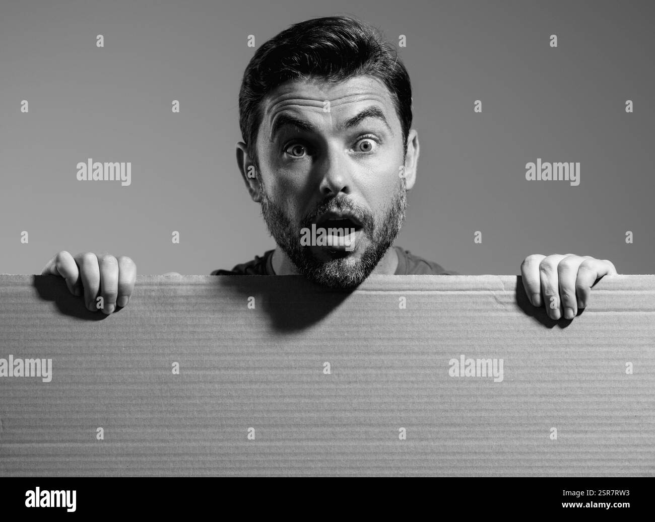 Surprised man holds the white sign, blank card. Placard ready for your ...