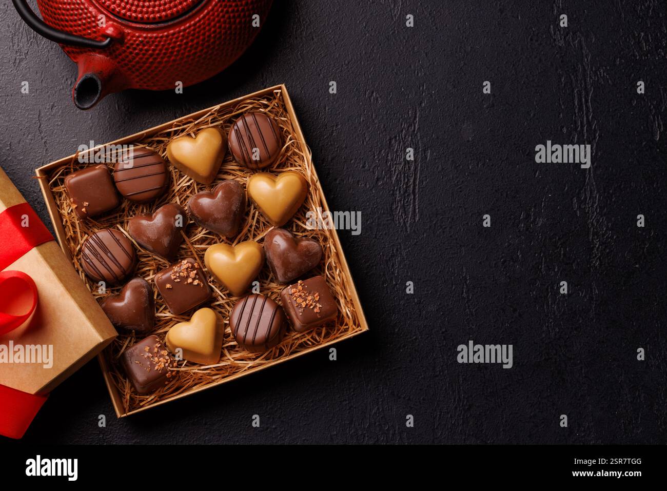 A romantic Valentines Day setup featuring a box of assorted chocolates ...