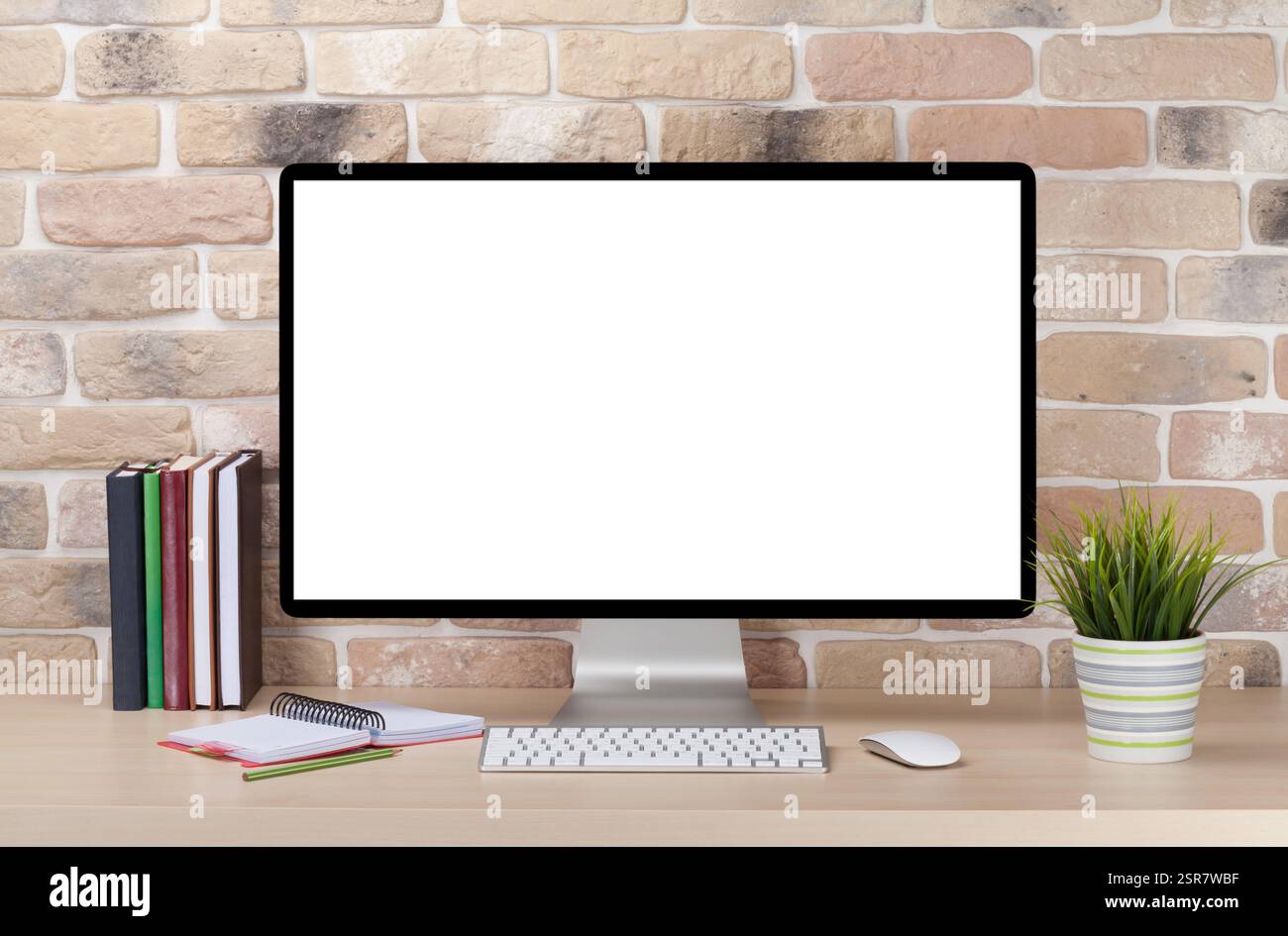 A cozy workplace setup featuring a PC with a blank screen monitor on a ...