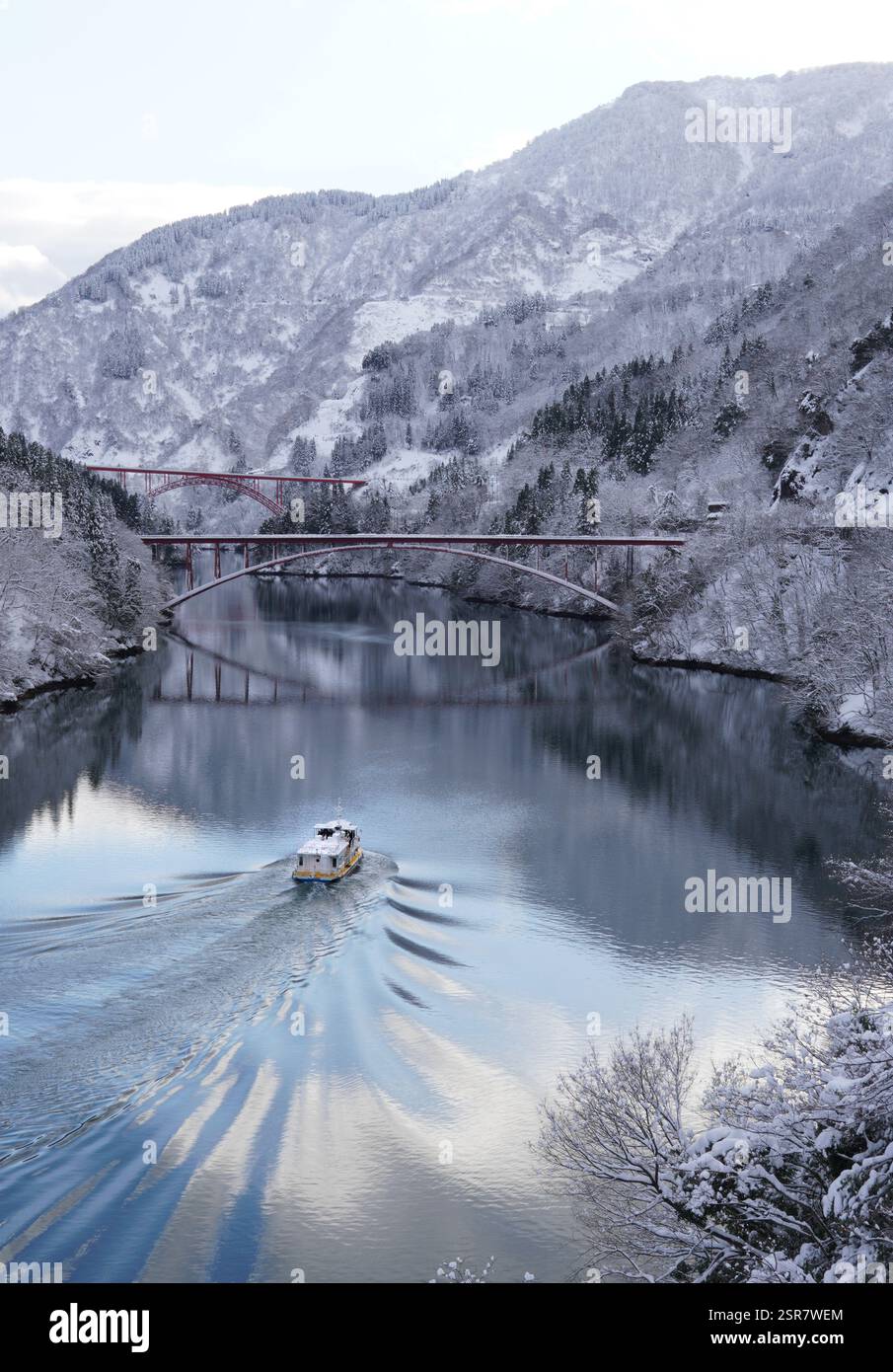 A scenic boat cruise on the Shogawa River in winter, surrounded by snow ...