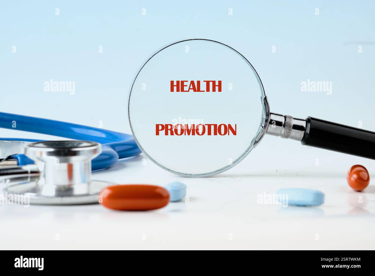 A magnifying glass showcases Health Promotion among medical tools ...