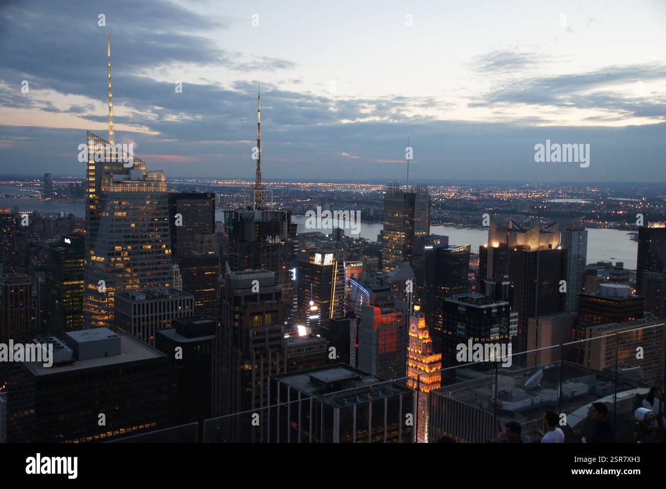 Aerial view of New York City skyline at dusk. Buildings illuminated ...