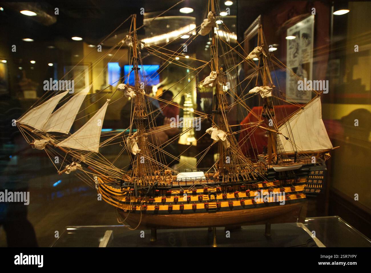 A meticulously crafted wooden ship model, complete with masts and ...