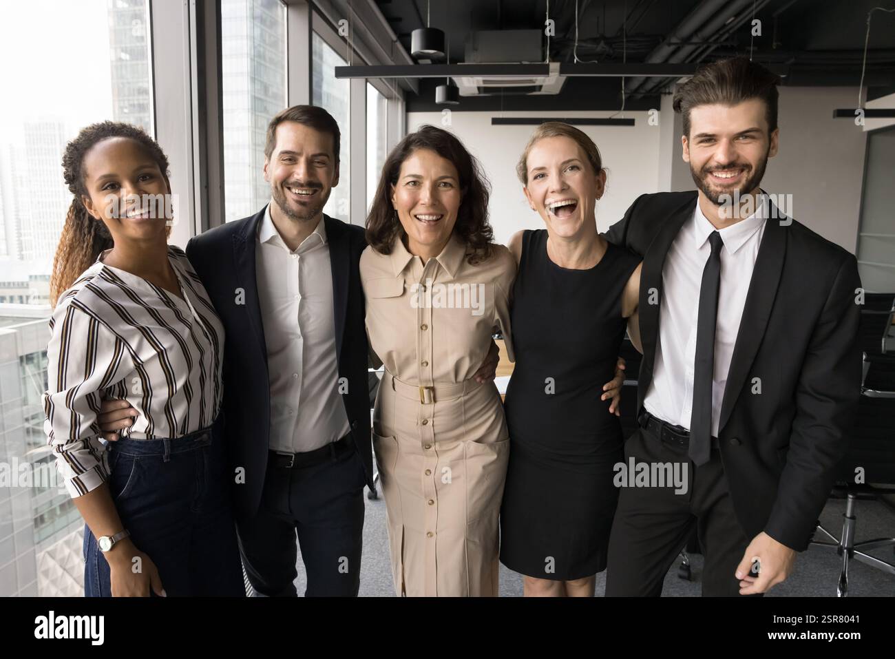 Diverse group of five businesspeople standing together in office Stock ...