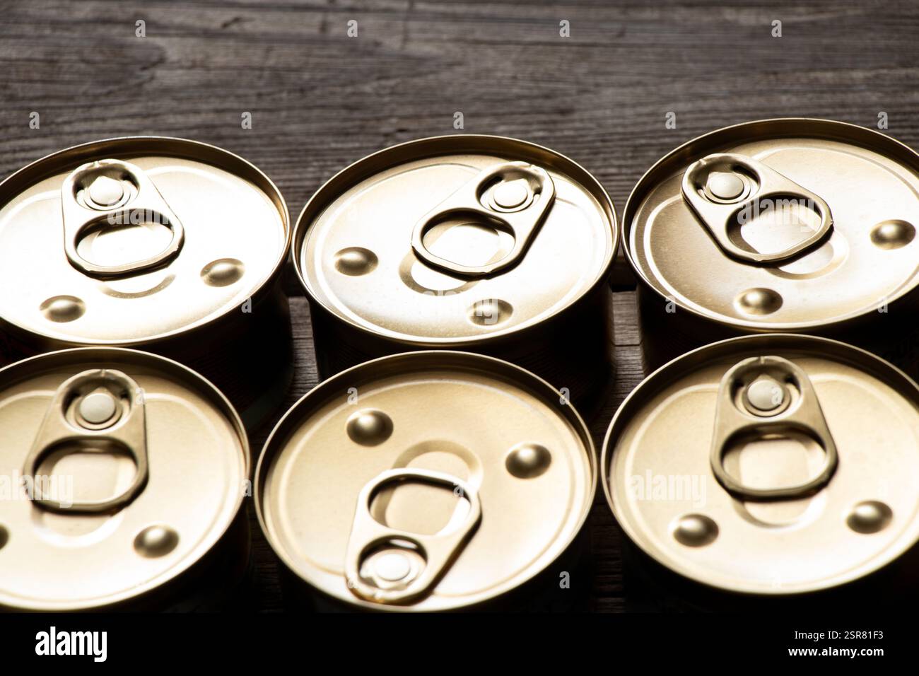 Six tin cans on a wooden table, food in tin cans Stock Photo - Alamy