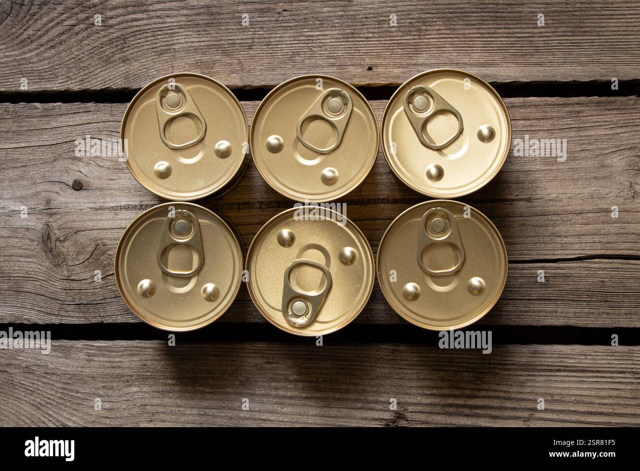 Six tin cans on a wooden table, food in tin cans Stock Photo - Alamy