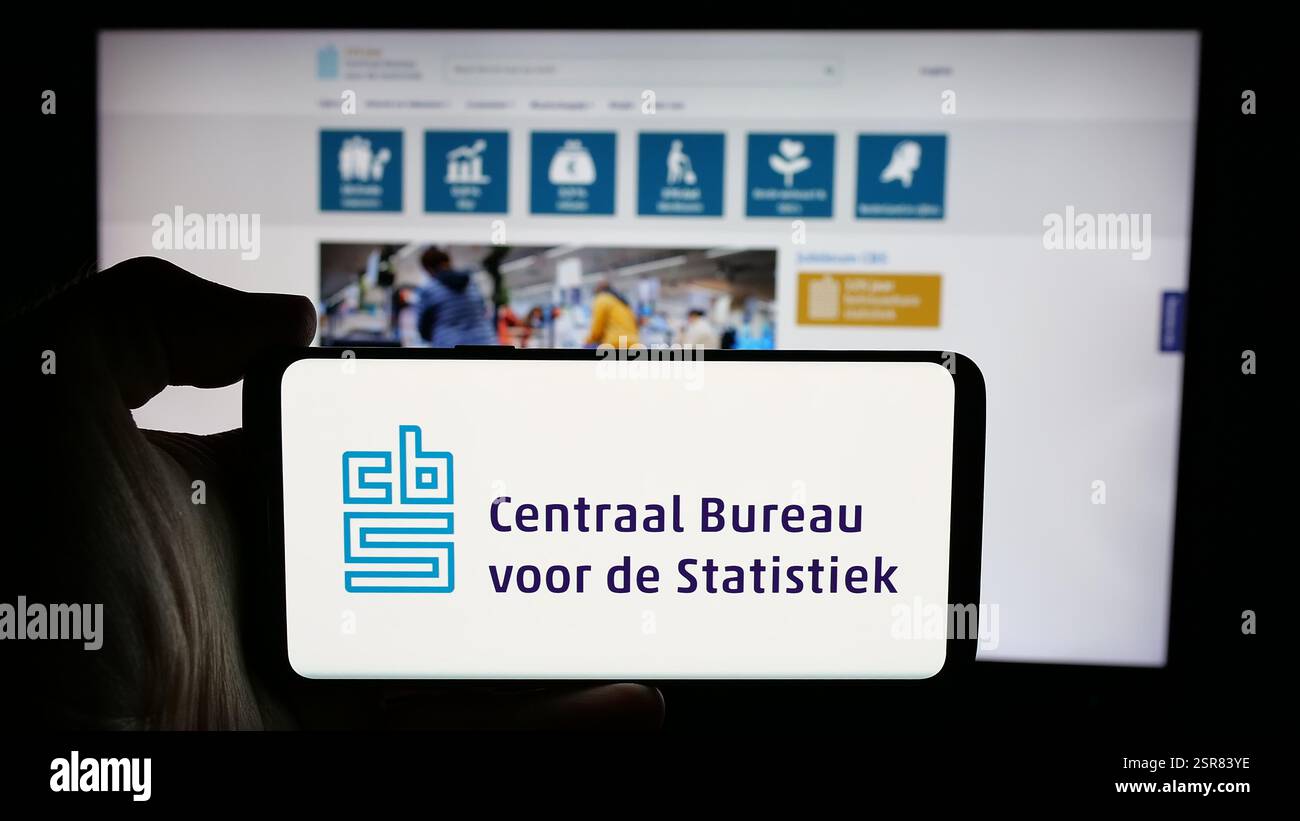 In this photo illustration, a person is holding a cellphone with the ...