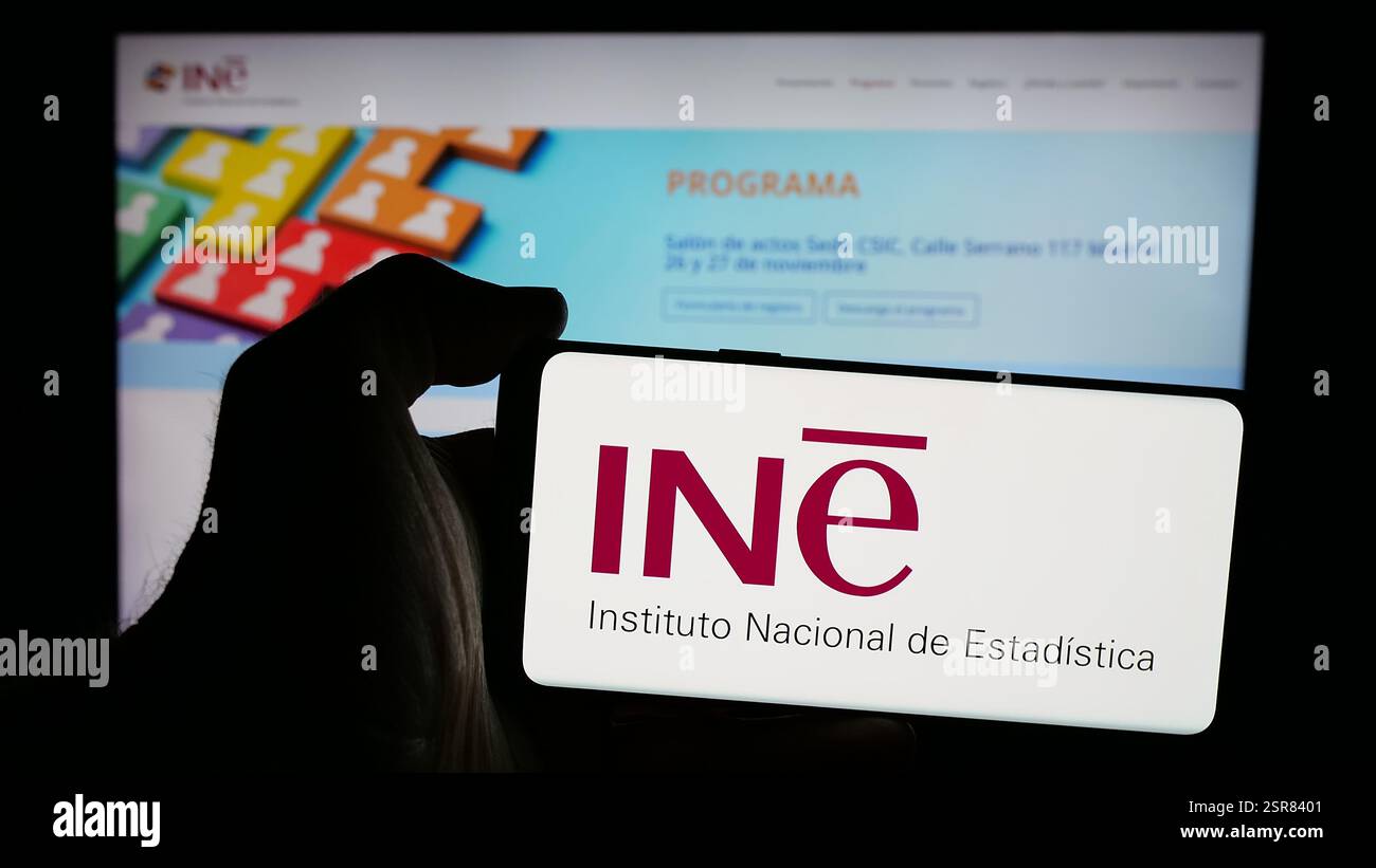 In this photo illustration, a person is holding a mobile phone with the ...