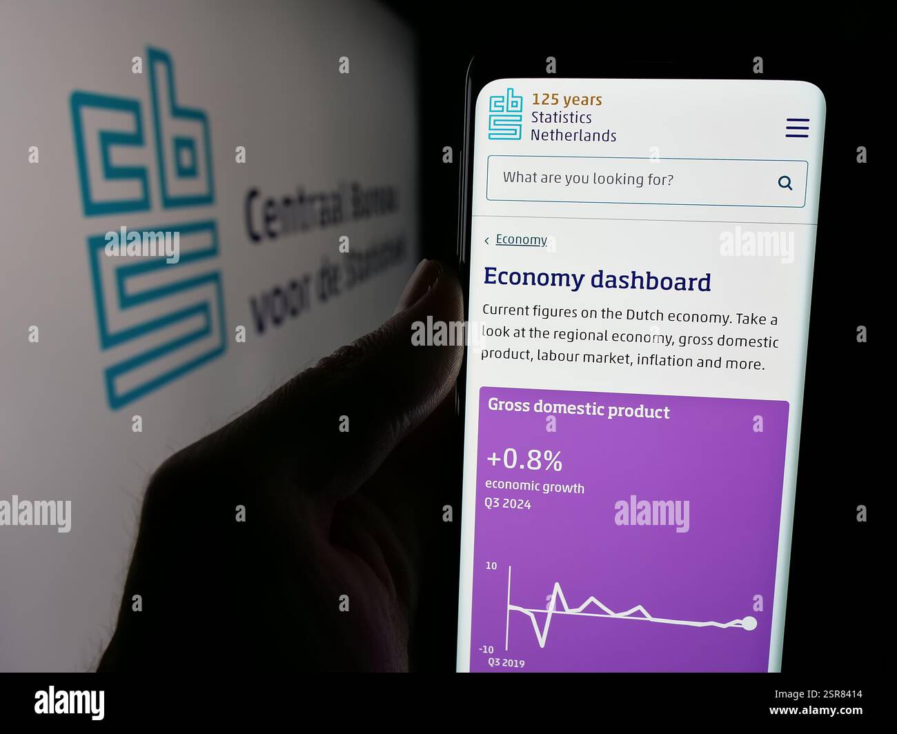 In this photo illustration, a person is holding a cellphone with the ...