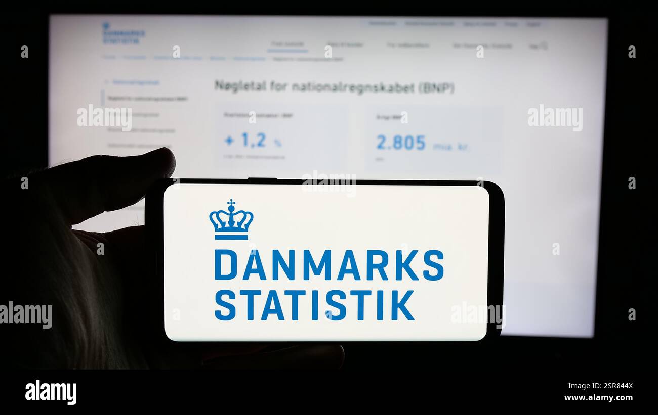 In this photo illustration, a person is holding a cellphone with the ...