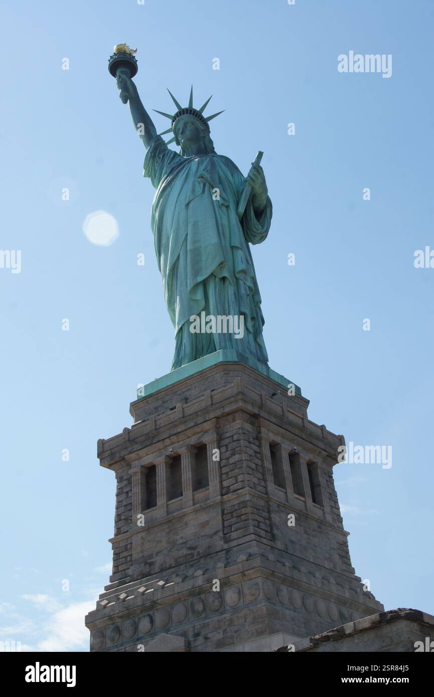 New York, Manhattan. The Statue of Liberty stands tall on a clear day ...
