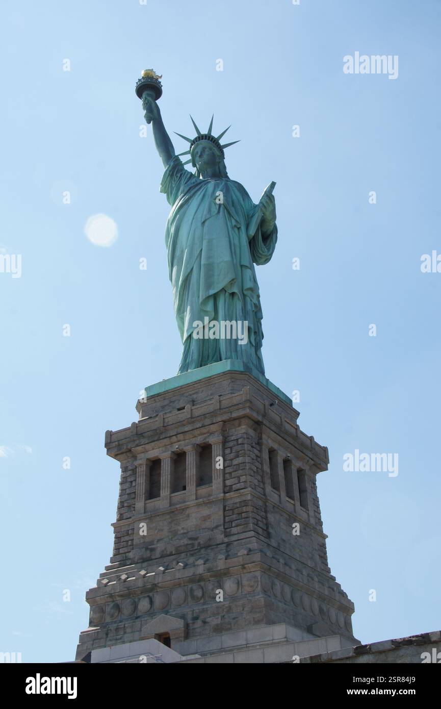 New York, Manhattan. The Statue of Liberty stands tall against a clear ...