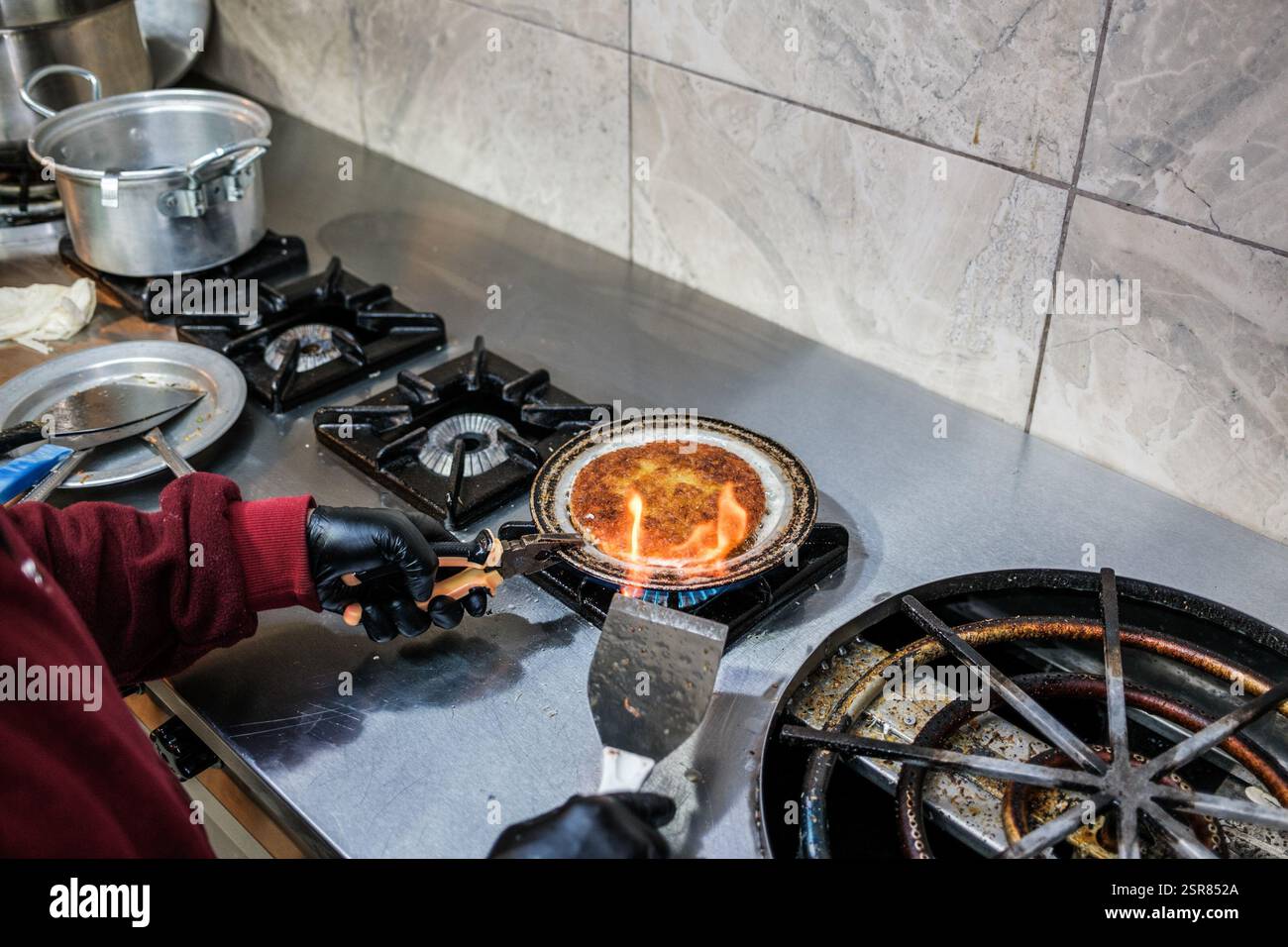 Hatay, Antakya, Turkey. 11th Feb, 2025. The kunafa is cooked on a stove ...