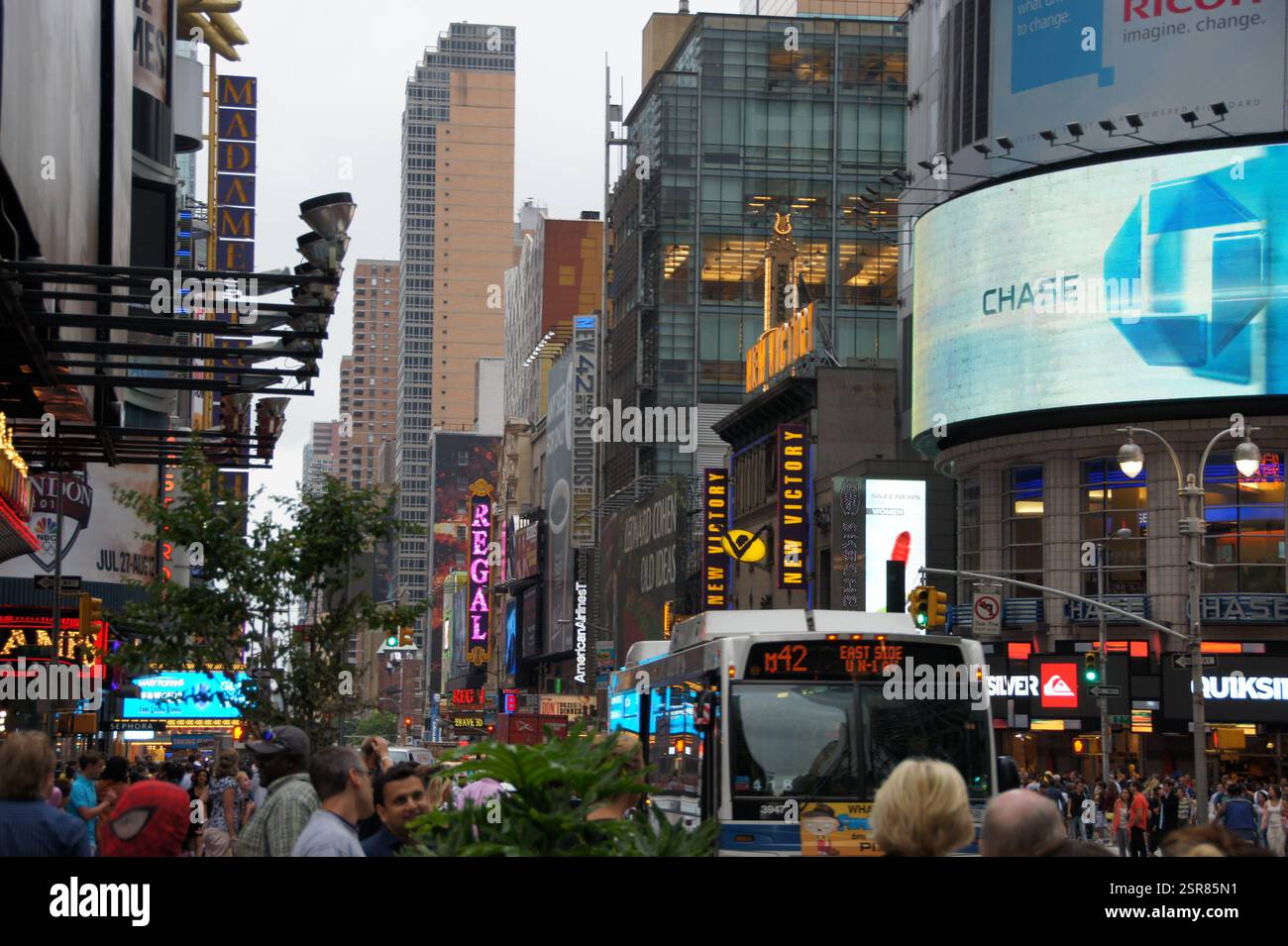 Manhattan bursts with cheer! A vibrant cake, crowned with flickering ...