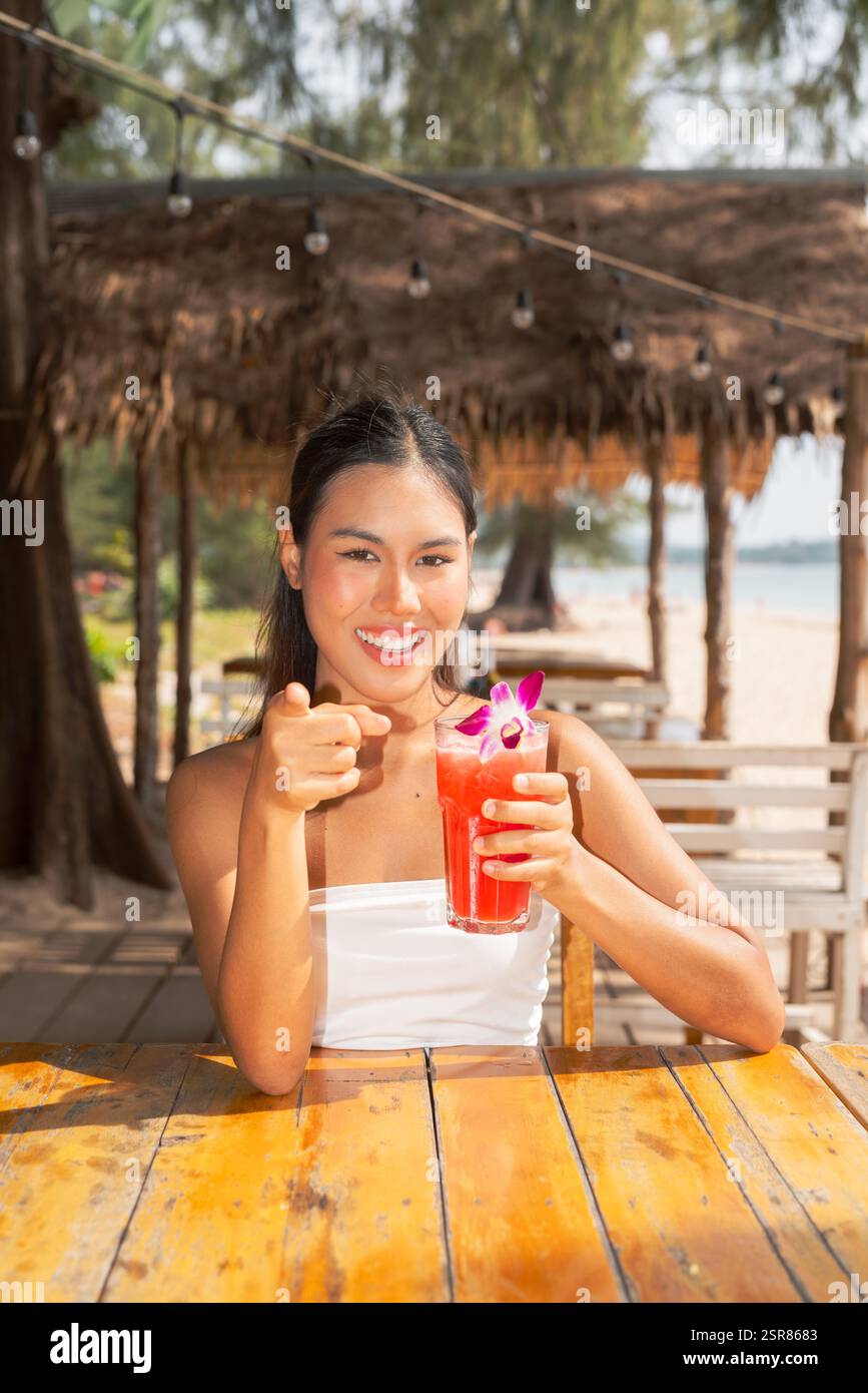 Young woman drinking watermelon drink at the beach in Thailand Stock ...