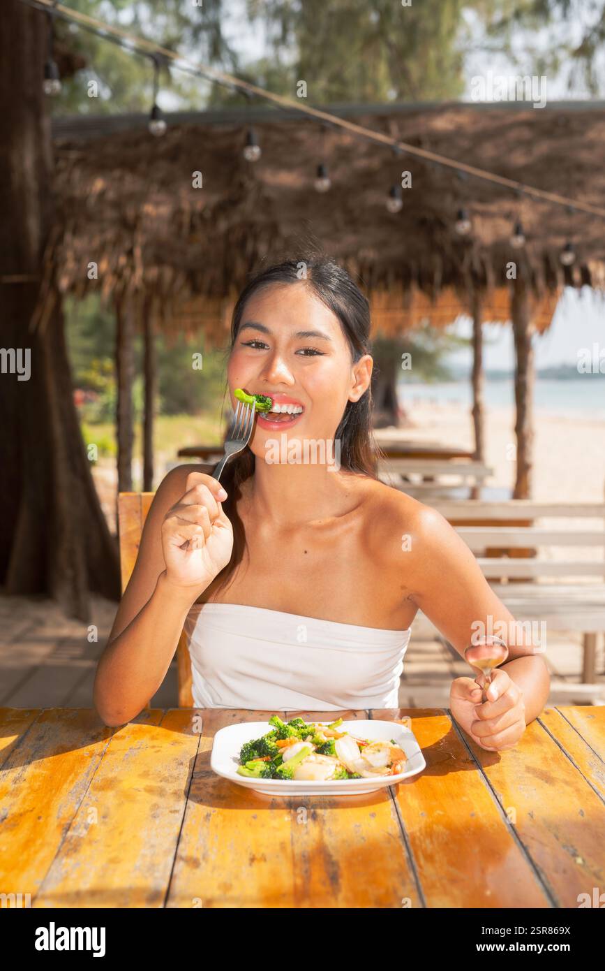 Young beautiful woman eating healthy meal in the restaurant Stock Photo ...