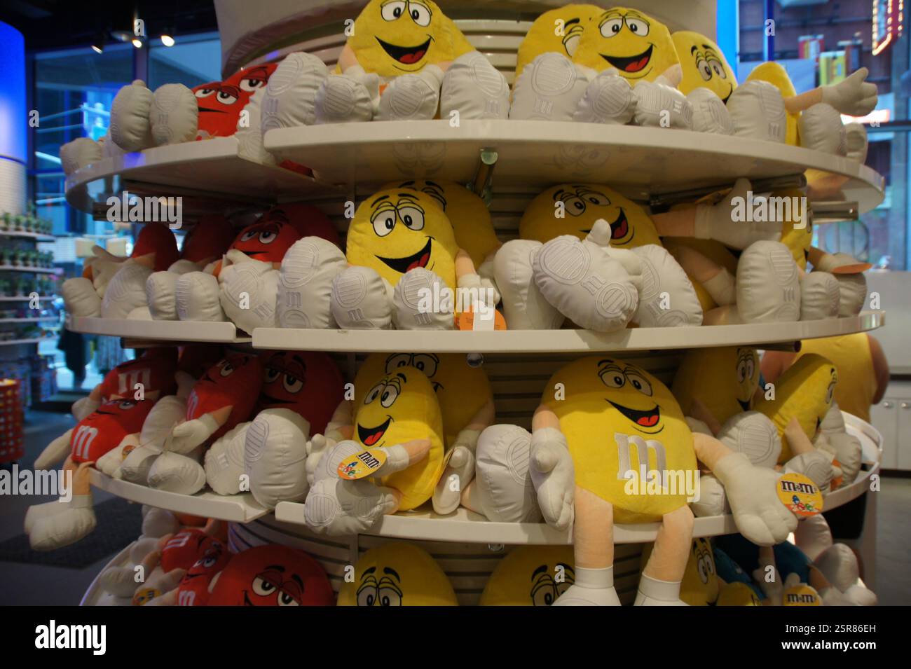 A brightly colored display of M&M's merchandise fills a store shelf in ...