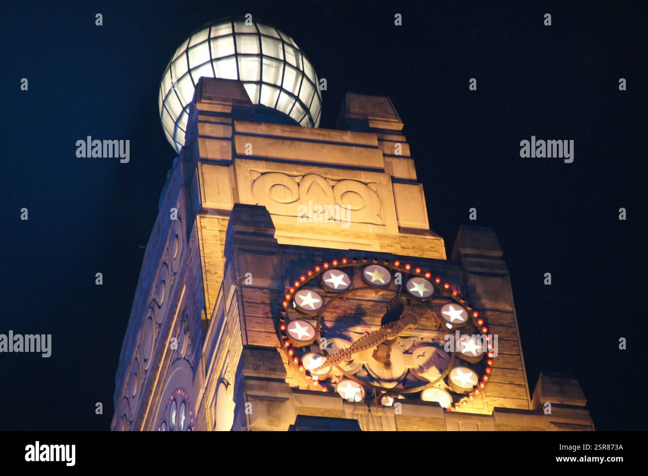 Illuminated Art Deco clock tower in New York, Manhattan, crowned by a ...