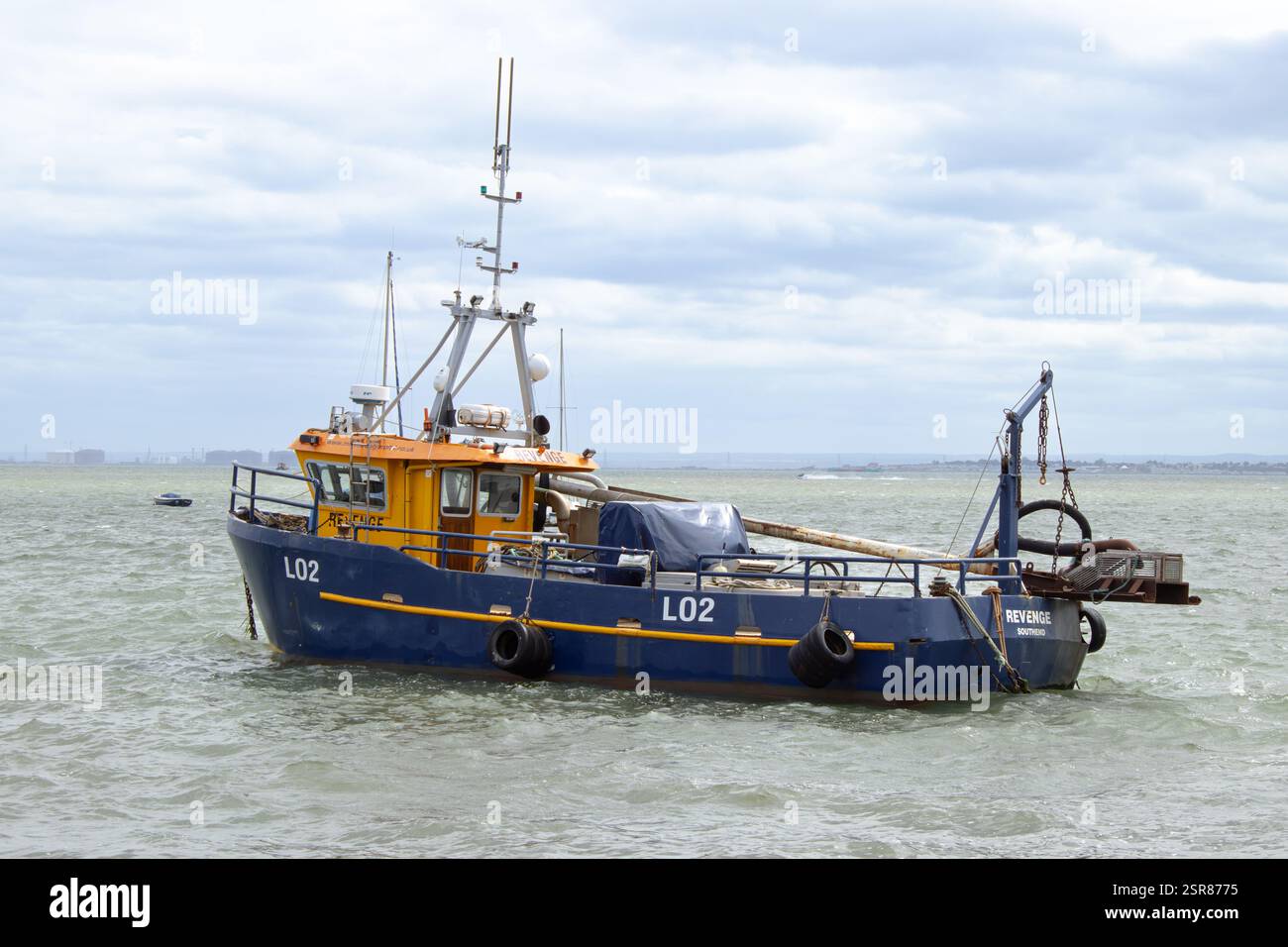 Blue and Orange Cockle Boat floating on the waterfront at Old Leigh ...