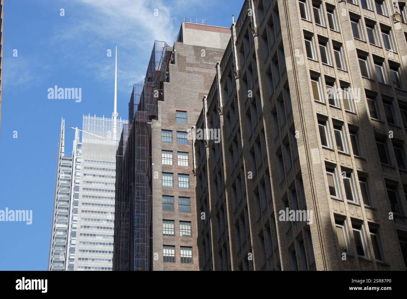 In New York, Manhattan, glass and steel skyscrapers pierce a clear blue ...