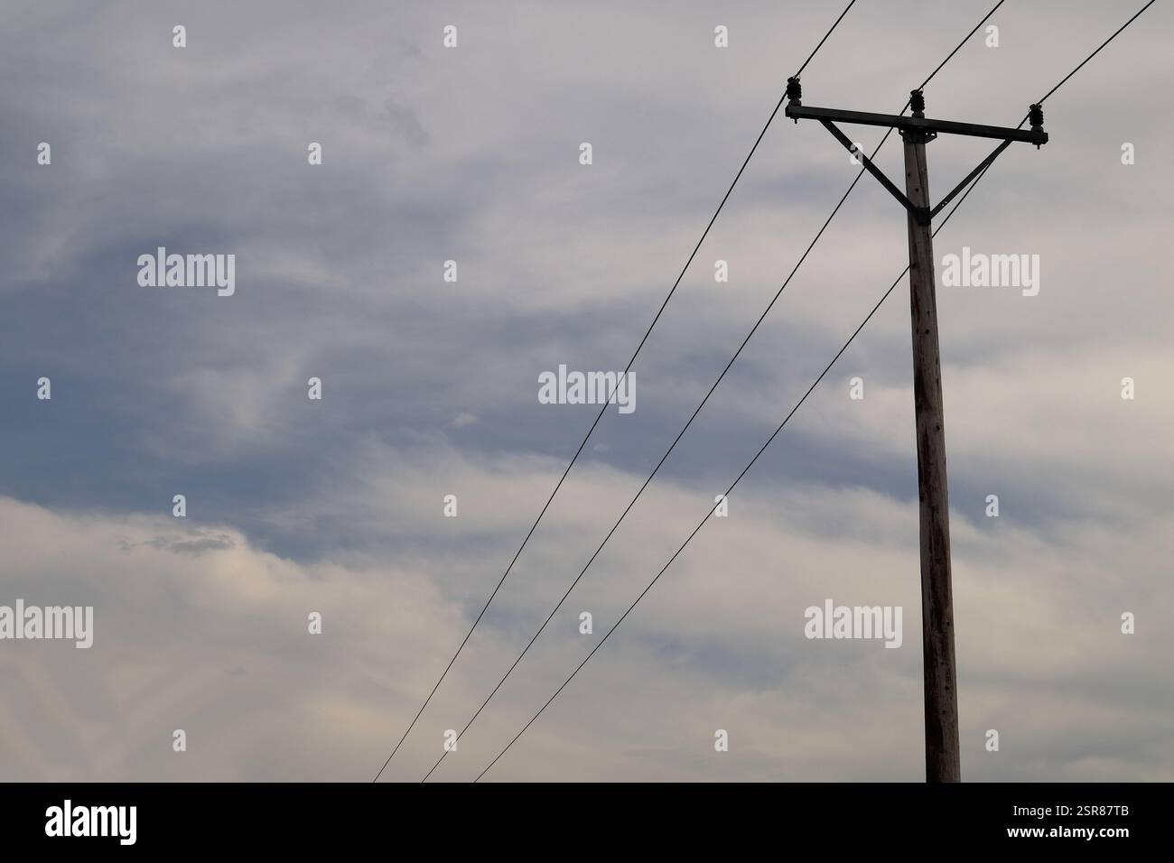 Power lines one cloudy day. Old wooden poles with 0,4 kV electricity ...