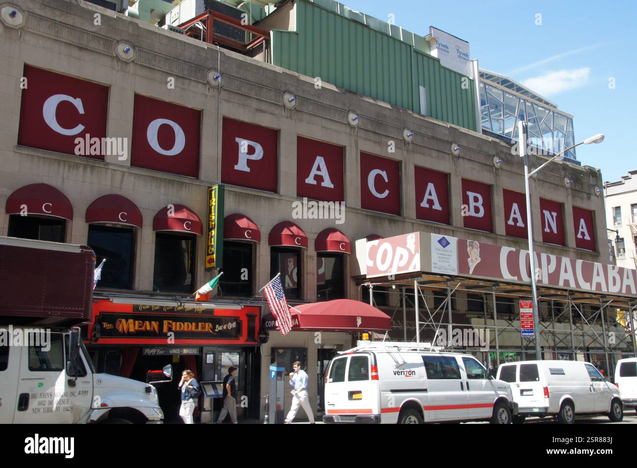 A colorful sign with text in multiple languages, likely for a nightclub ...