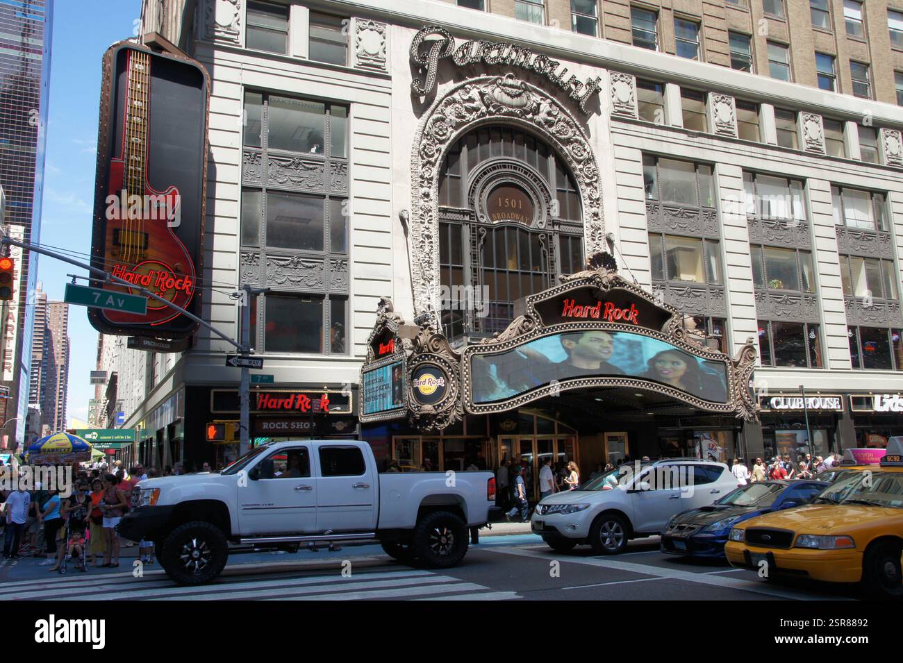 A cacophony of lights and colors fills a nighttime scene in Times Square, New York, Manhattan ...