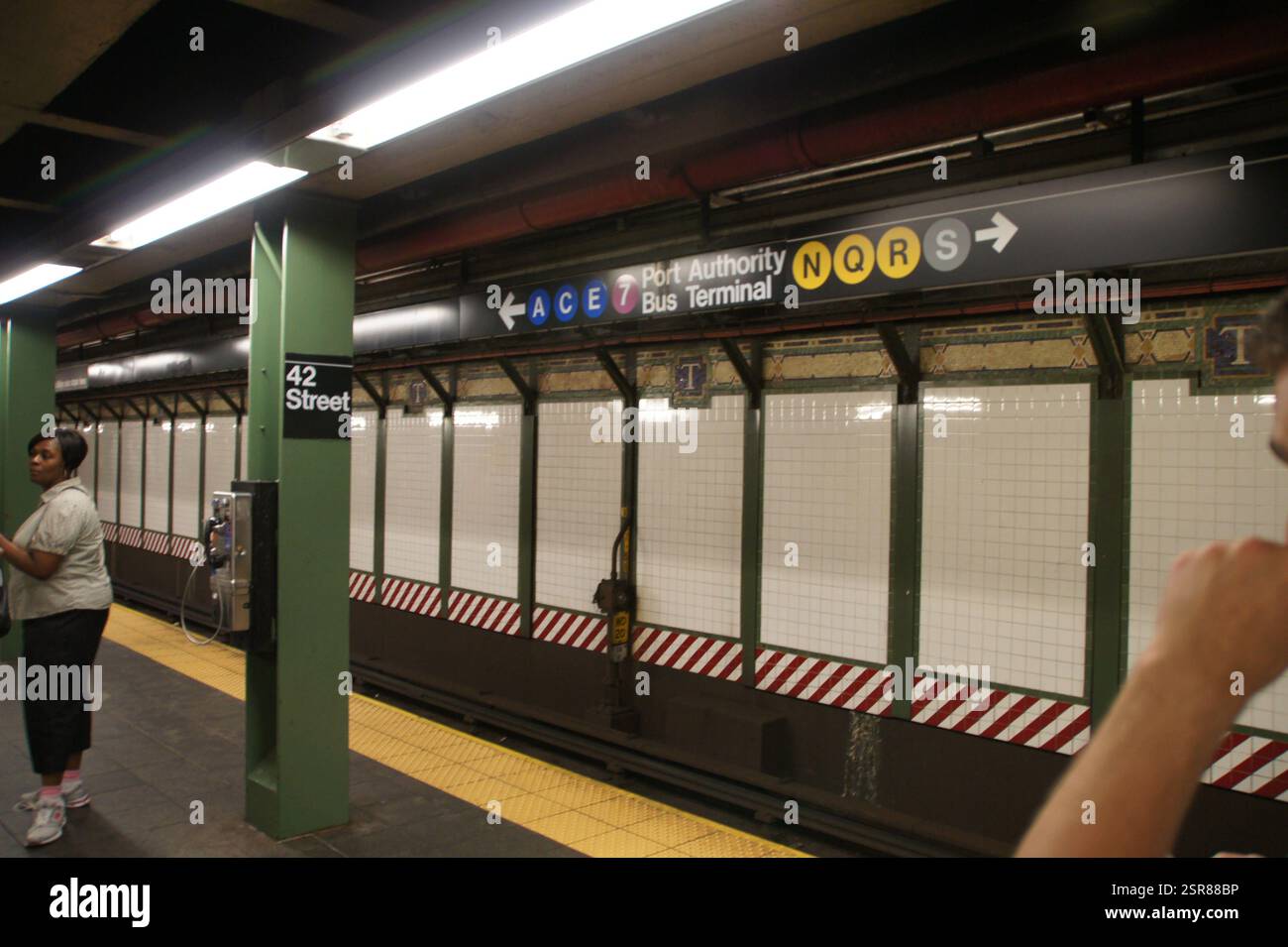 A bus stop sign in New York, Manhattan displays routes and destinations ...