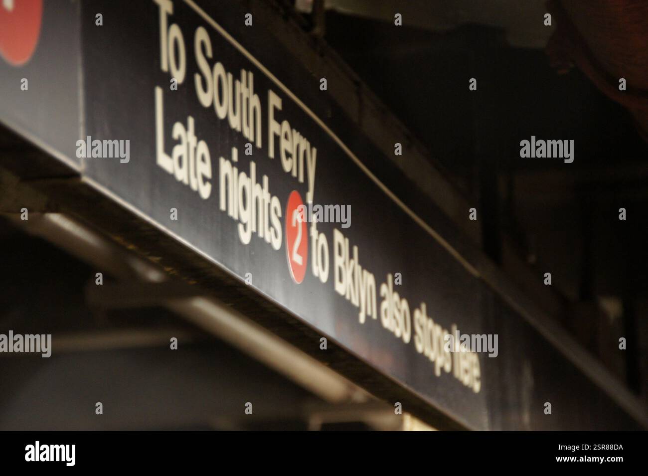 A subway station sign in New York, Manhattan directs passengers towards ...