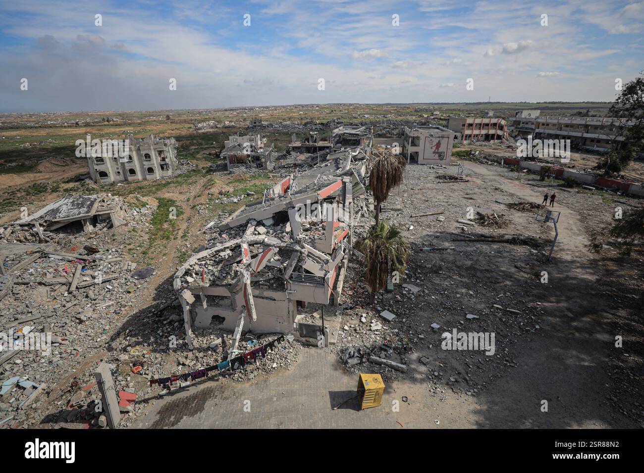 A view of the demolished residential area shows Palestinians continuing ...