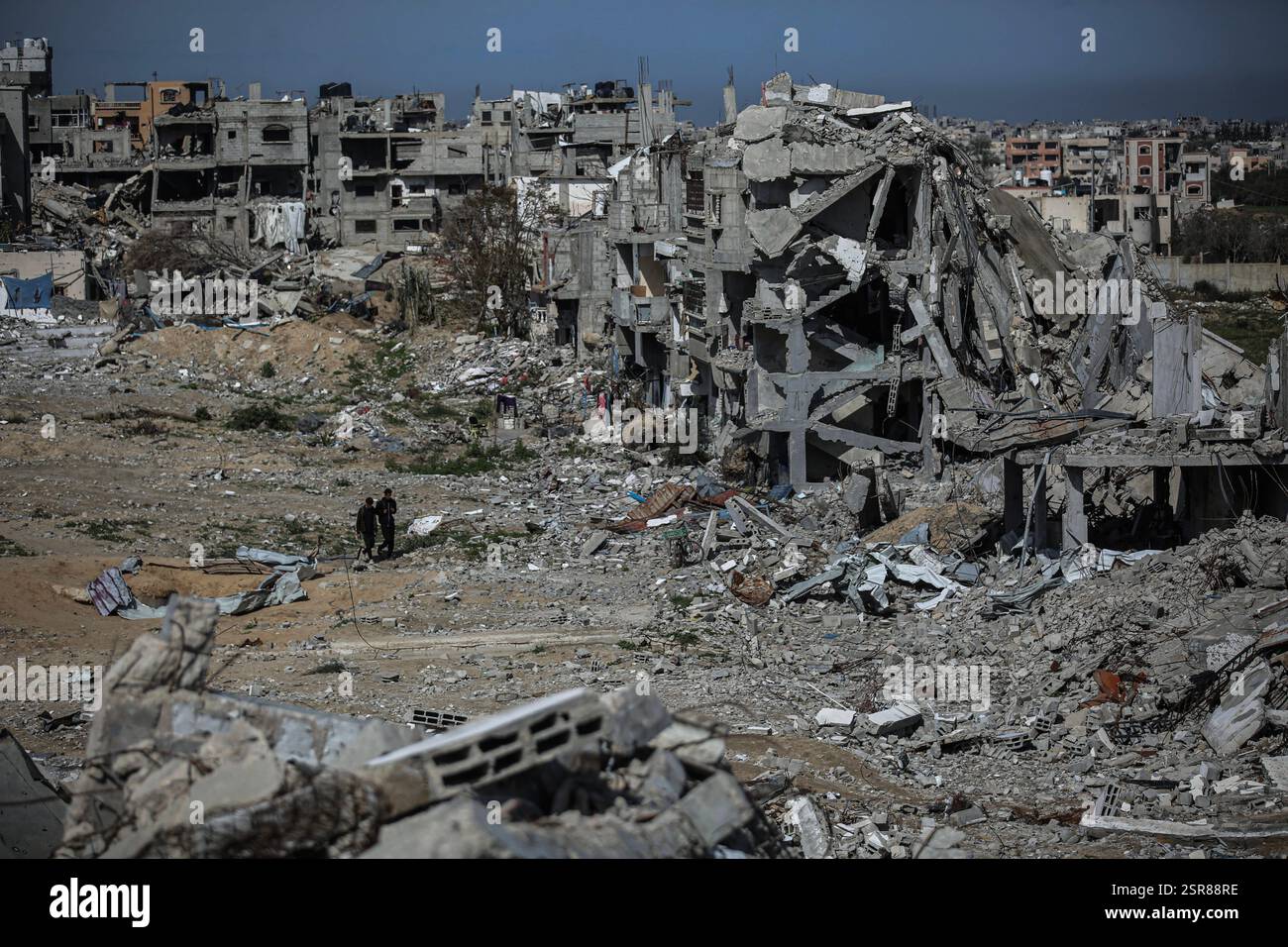 A view of the demolished residential area shows Palestinians continuing ...