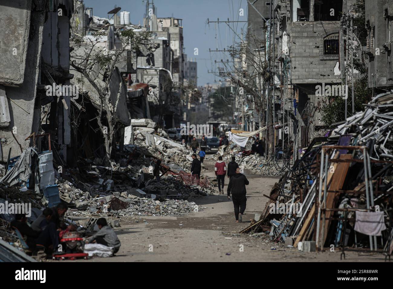 A view of the demolished residential area shows Palestinians continuing ...