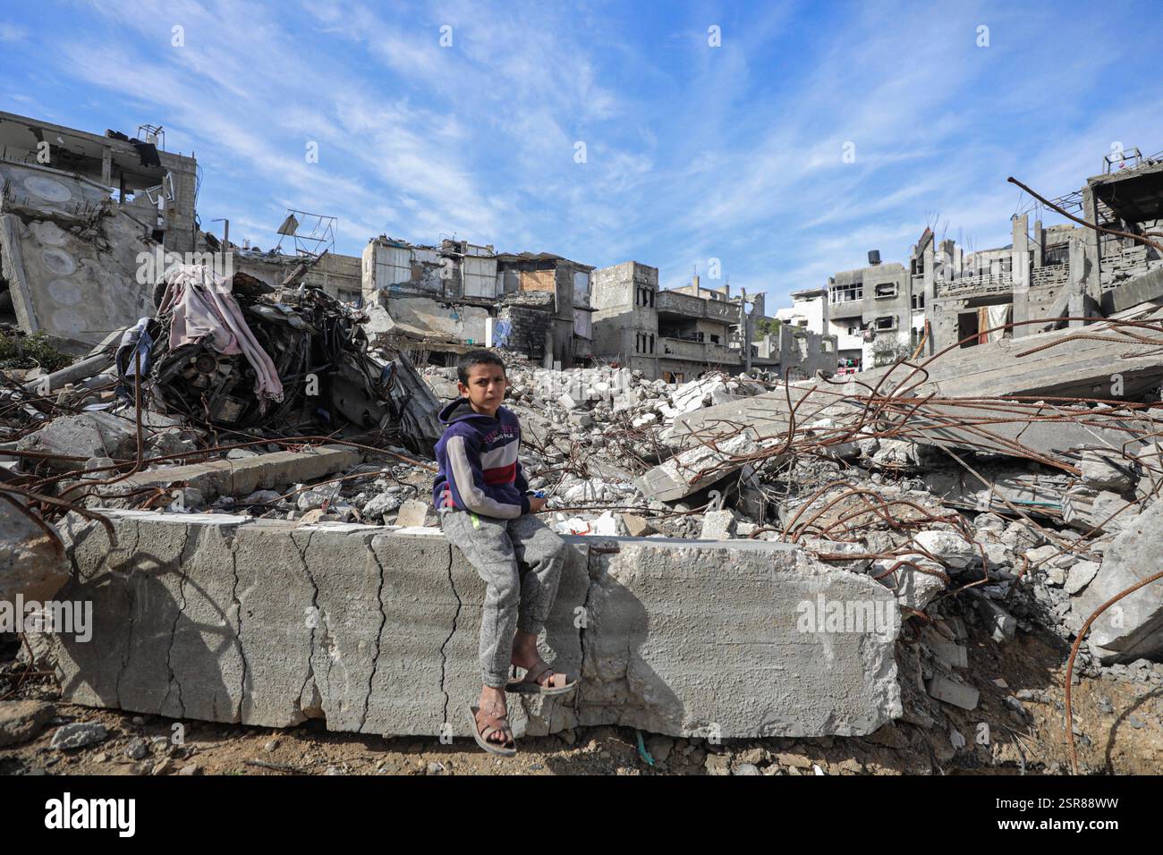A view of the demolished residential area shows Palestinians continuing ...