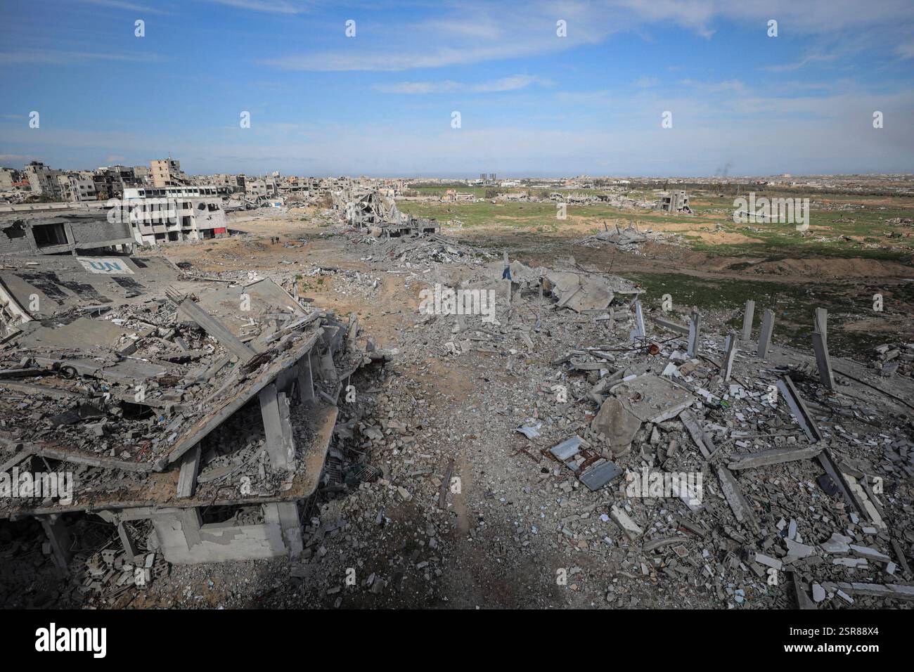 A view of the demolished residential area shows Palestinians continuing ...