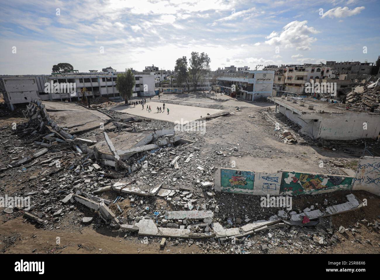 A view of the demolished residential area shows Palestinians continuing ...