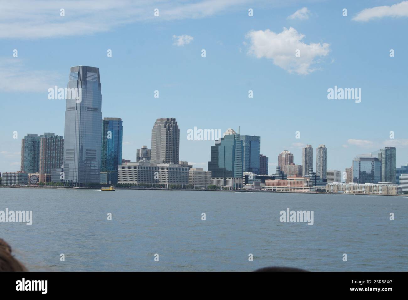 New York, Manhattan's skyscrapers pierce the sky, their reflections ...