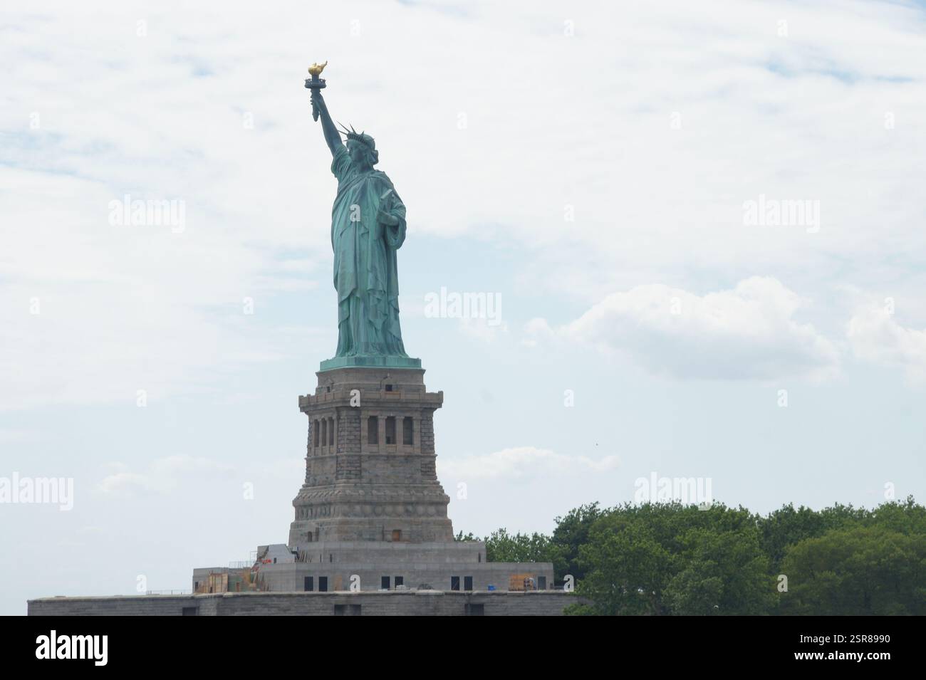 A majestic statue stands tall against a cloudy backdrop in New York ...