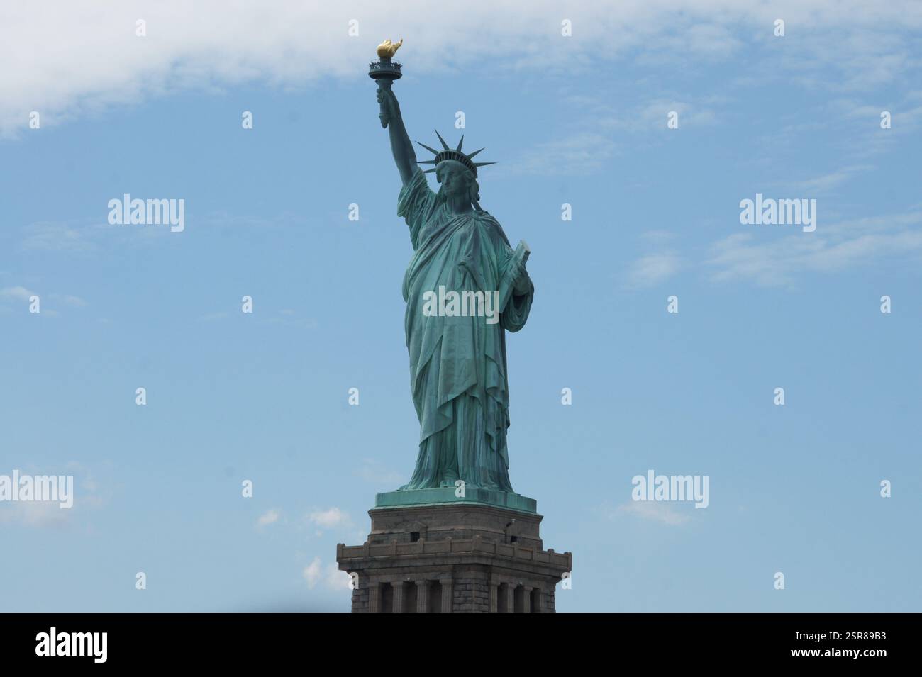 A majestic statue stands tall against a backdrop of clear blue sky in ...