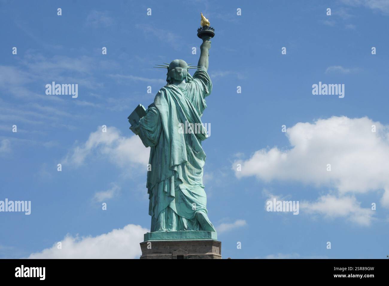 New York, Manhattan. The Statue of Liberty stands tall, bathed in ...