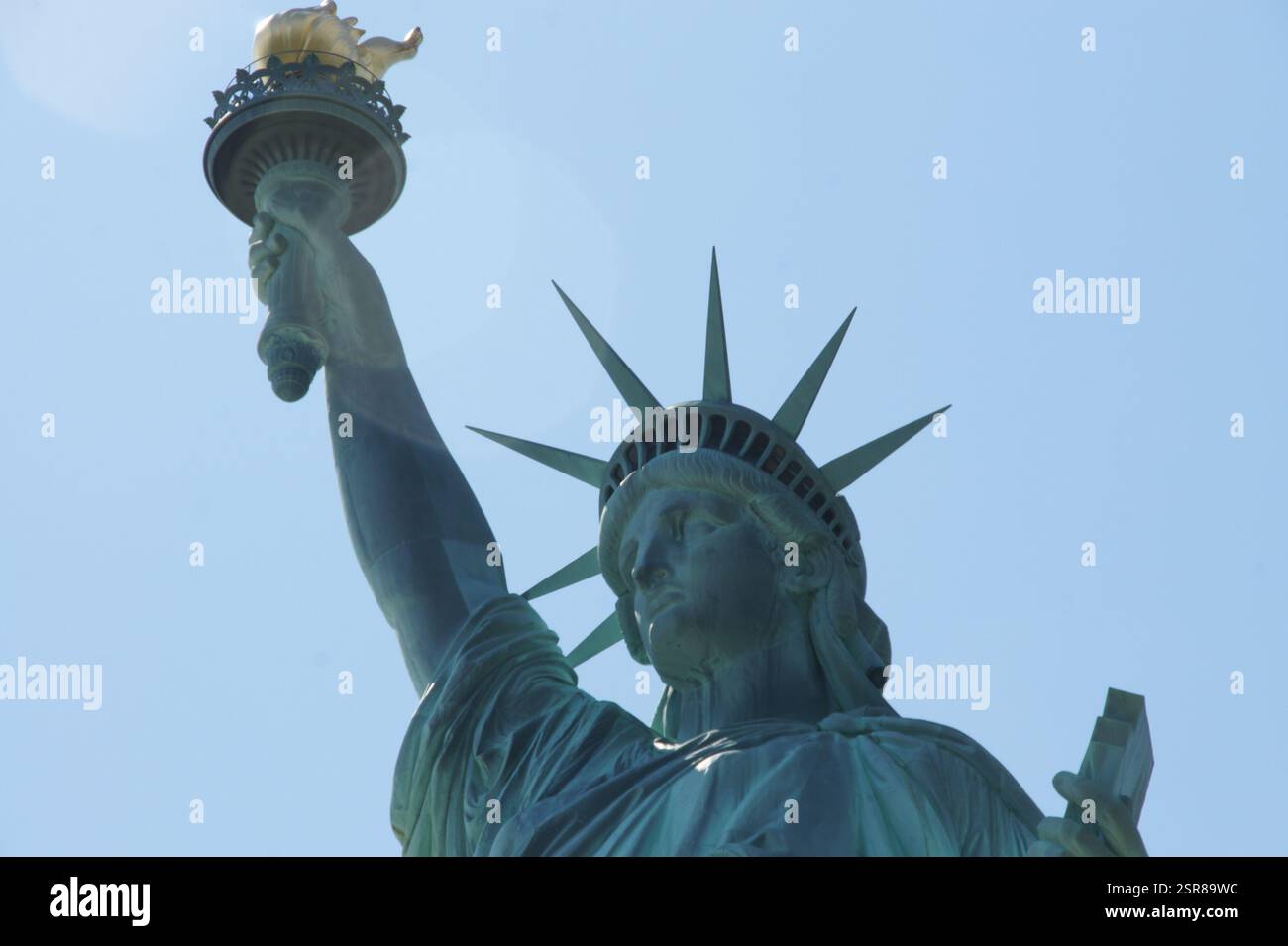 A close-up of the Statue of Liberty's copper crown, weathered green ...