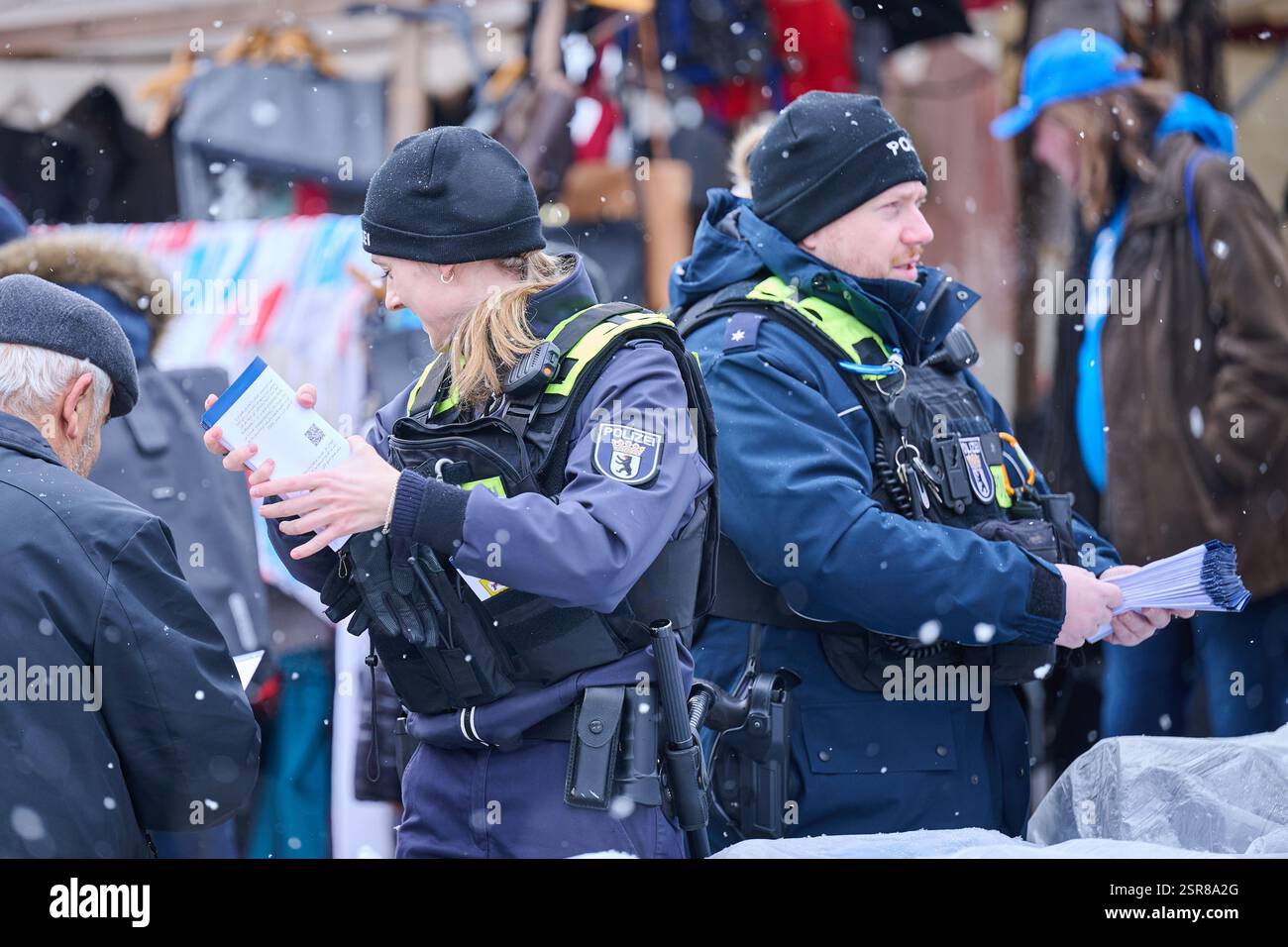 Berlin, Germany. 15th Feb, 2025. Police officers hand out flyers in ...