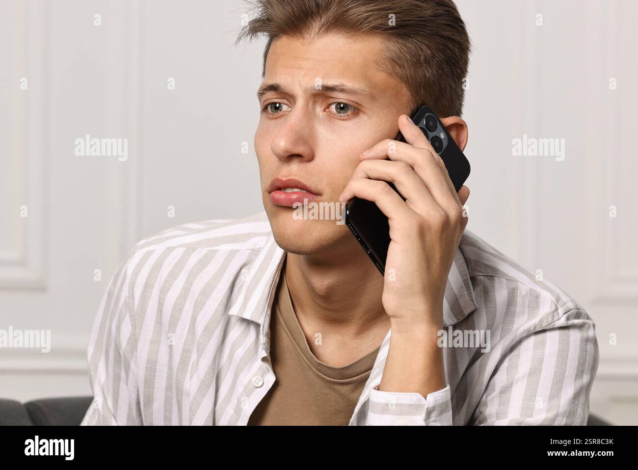 Worried man calling hotline hi-res stock photography and images - Alamy