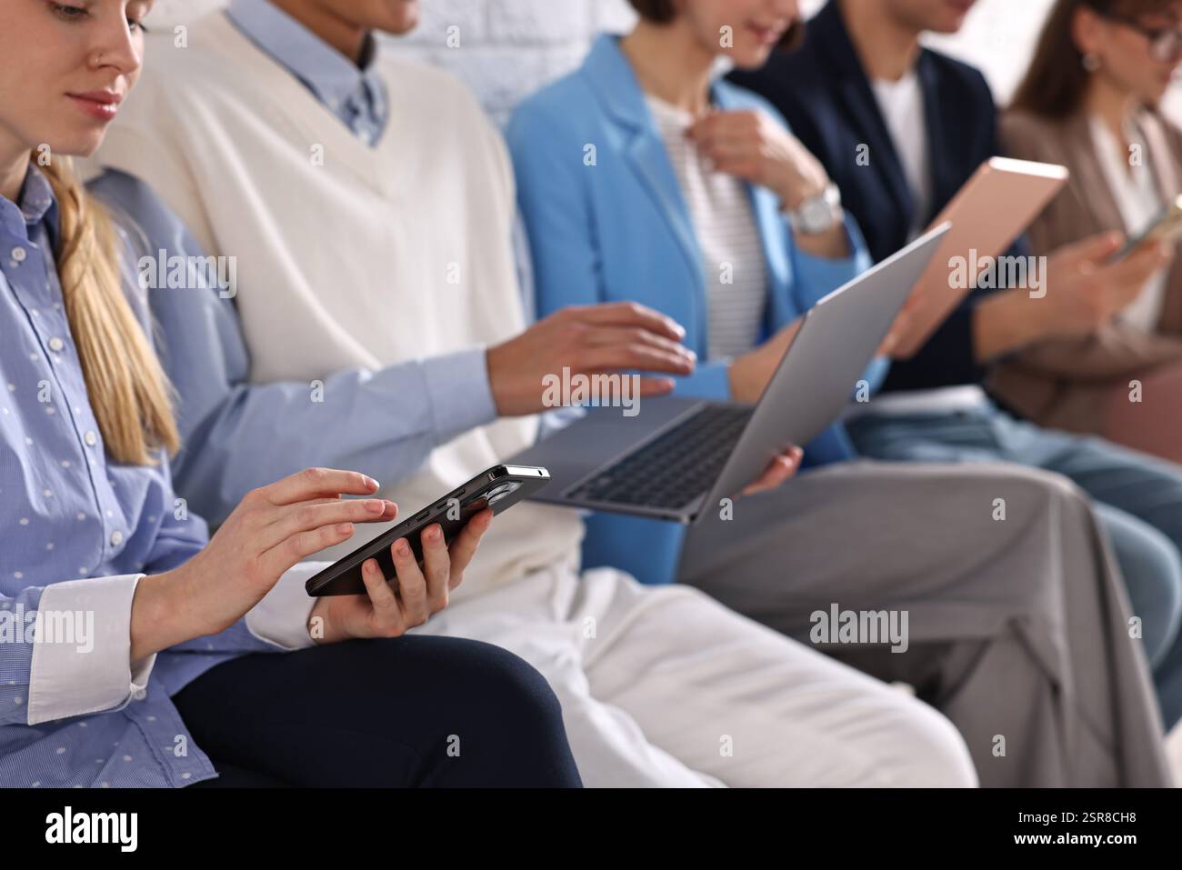 Group of people using different gadgets indoors, closeup. Modern ...