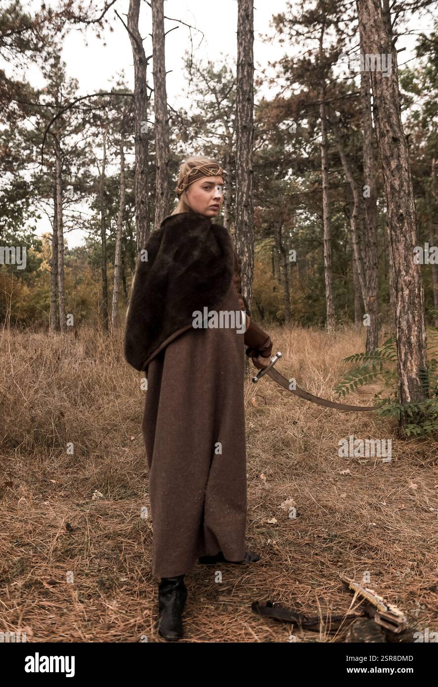 warrior girl with sword in hands in forest Stock Photo - Alamy