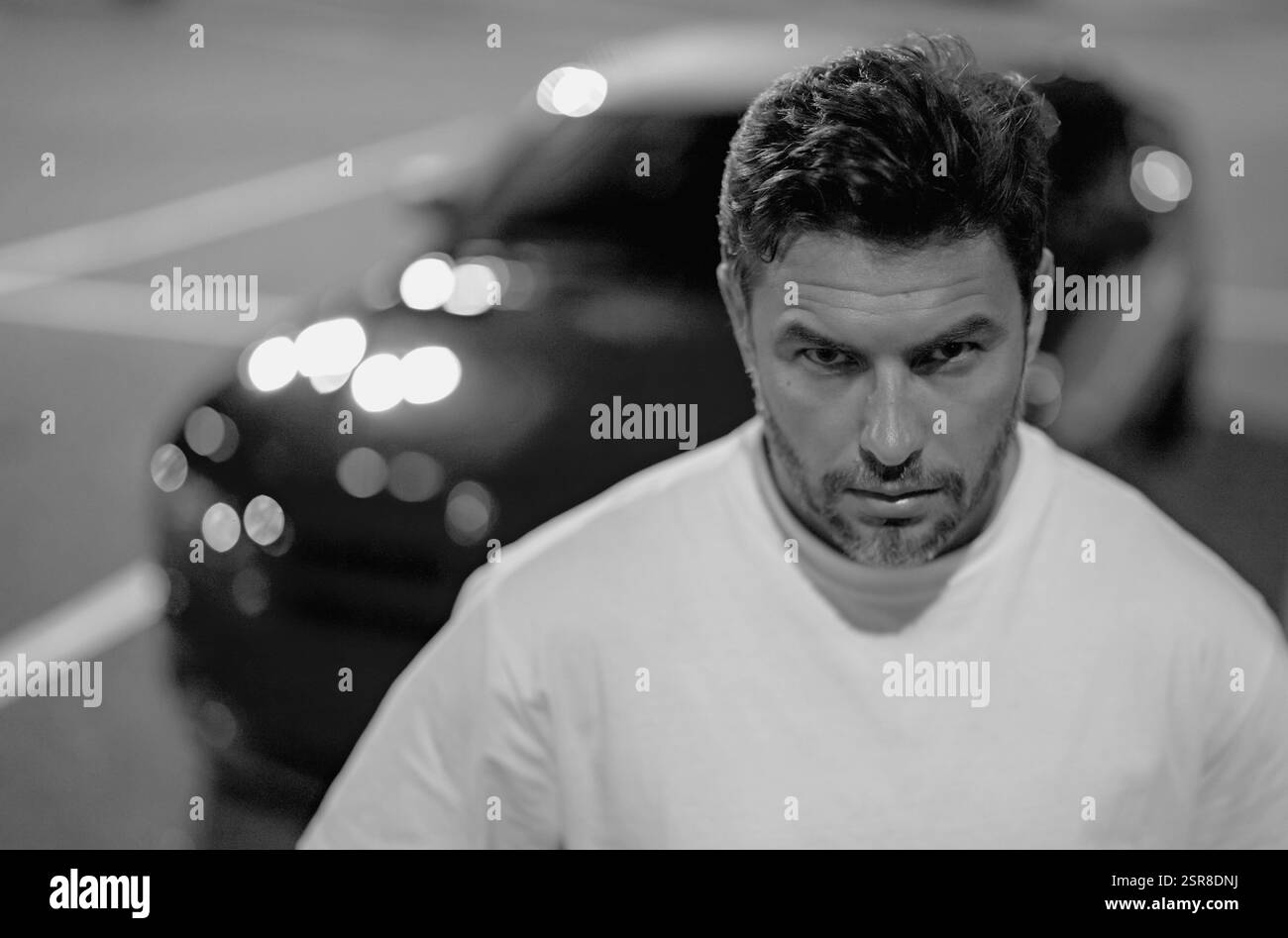 Gangster man. Dangerous angry man near car on night urban street ...