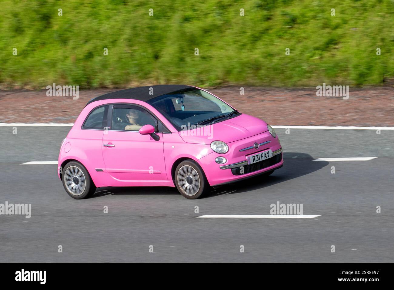 2010 Pink Fiat 500 C POP convertible, travelling on the M6 motorway UK ...