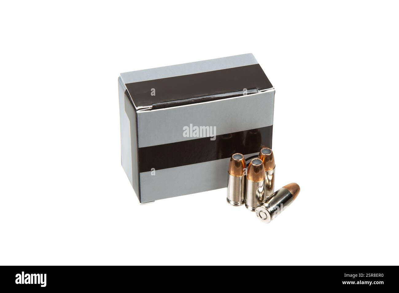 9mm ammunition, close-up view of four bullets placed beside a box ...