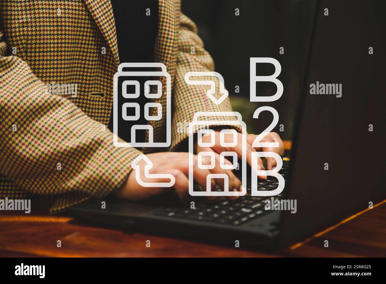 Business person types on a keyboard with digital icons representing B2B ...